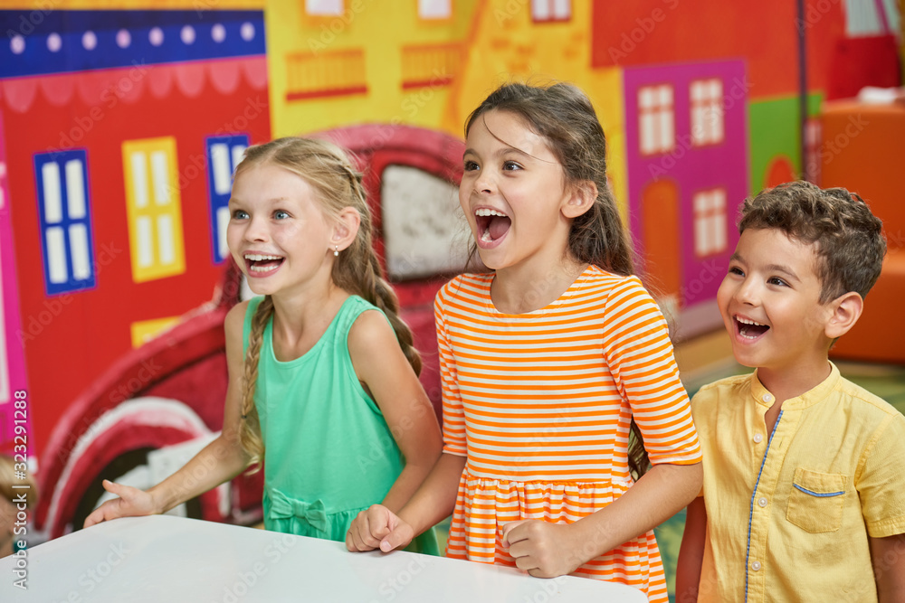 Three emotional kids in playroom. Show kids Birthday party. Fun ...