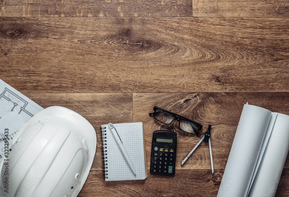 Creative layout of architects with roll drawings, engineering tools and ...