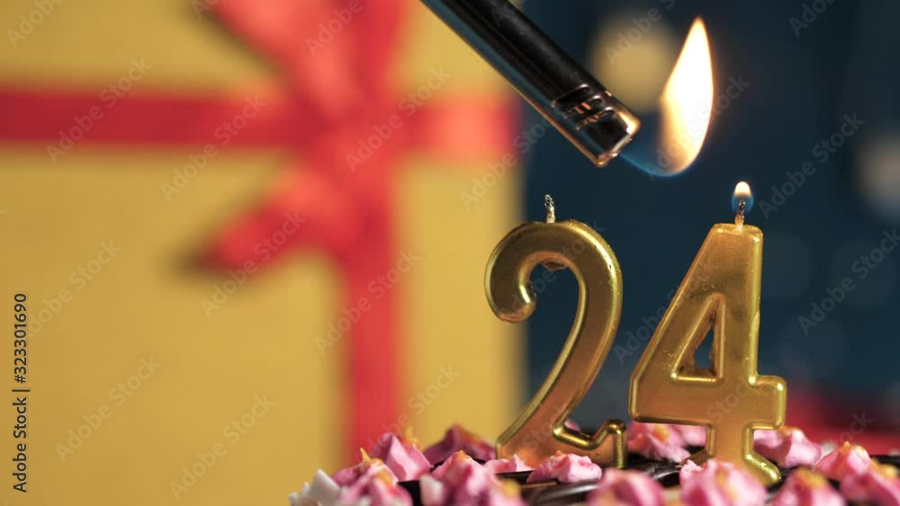 Birthday cake number 24 golden candles burning by lighter, blue ...
