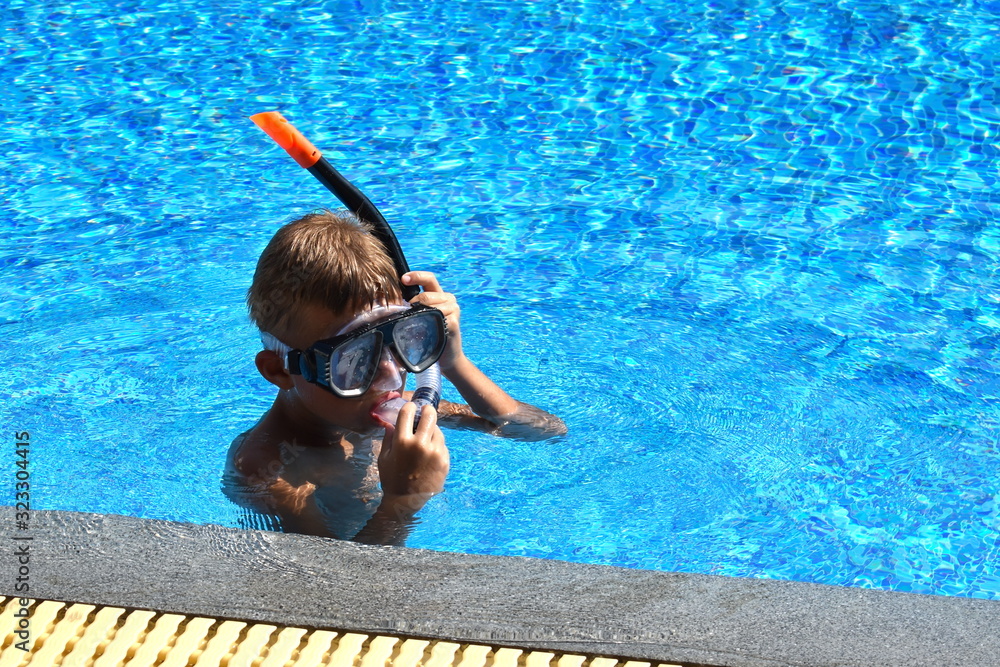 Baby boy in the water mask in the pool. Child swimmer in the water ...