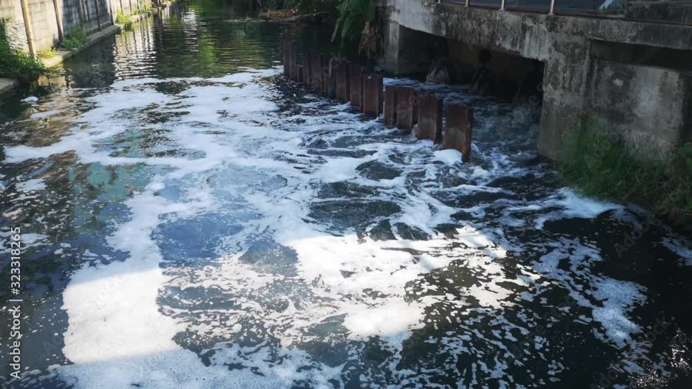 dirty water with bubbles foam flowing to sewer river , bad water from ...