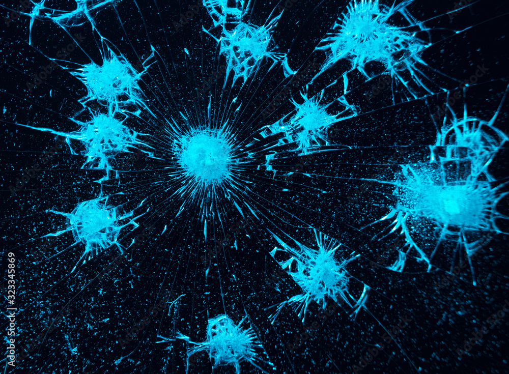 Set of blue cracks in window on black background. Broken glass texture ...