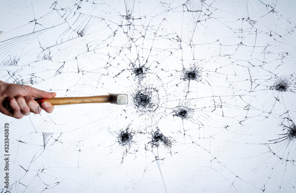 Hammer breaks the glass. Hammer smashes on glass Stock Photo | Adobe Stock