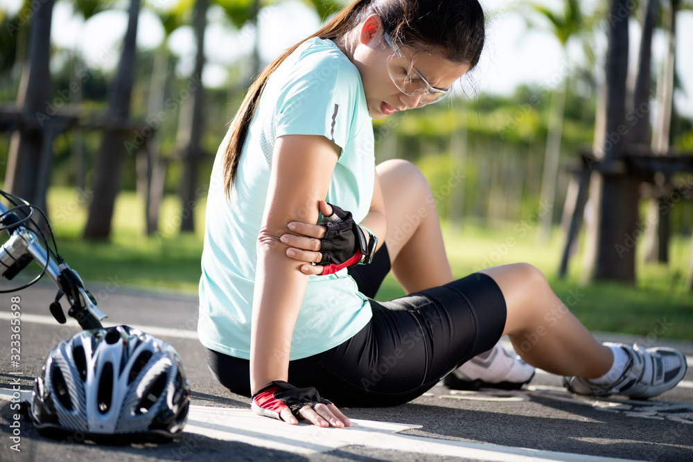 Bike injuries. Woman cyclist fell off road bike while cycling. Bicycle ...