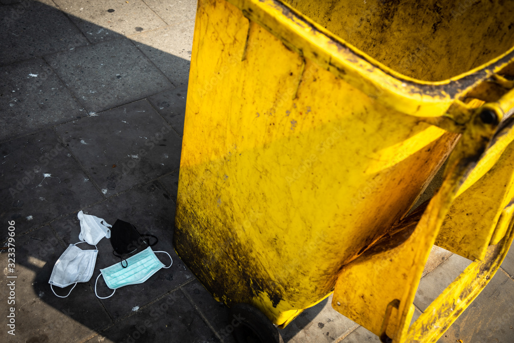 Person littering of garbage of used protective masks throw in the ...
