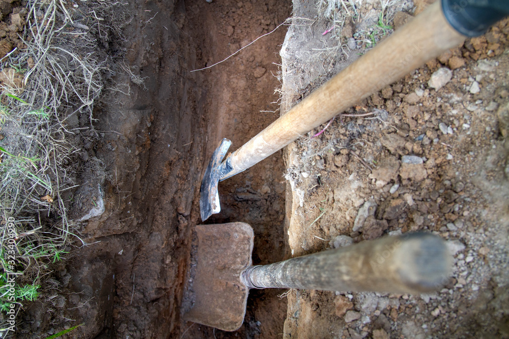 Shovels for digging trenches. Shovels stuck in the ground. Stock Photo ...