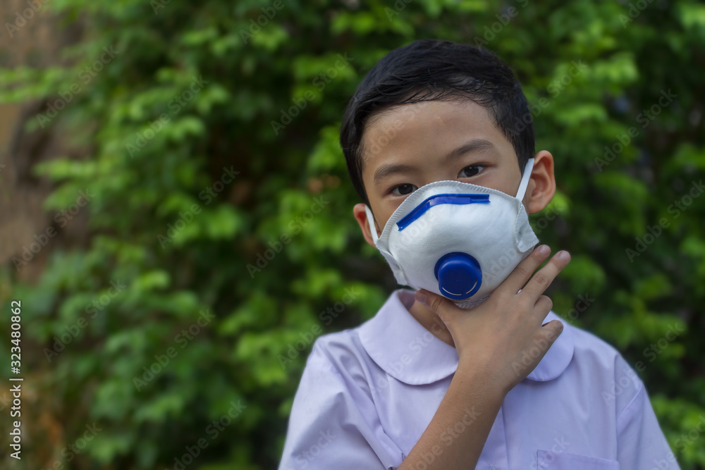 Handsome little boy in kindergarten uniform happiness to wear the dust ...