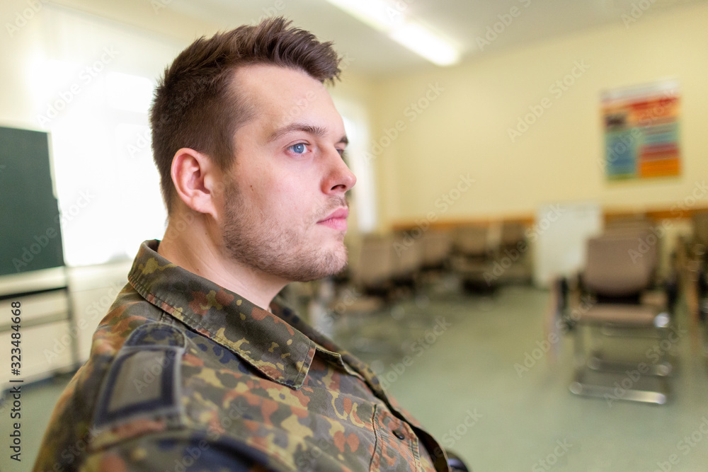 German soldier sits in a classroom . German word Bundeswehr, means ...