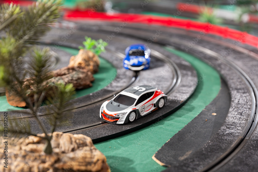 Electric slot cars on the toy race track Stock Photo | Adobe Stock
