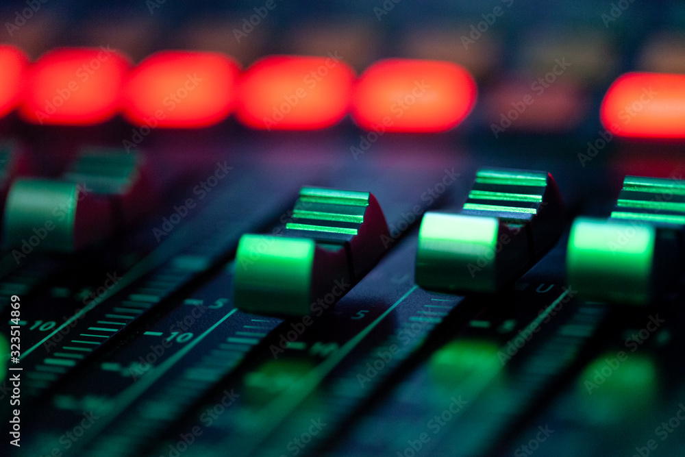 Volume control of the soundboard in green light Stock Photo | Adobe Stock