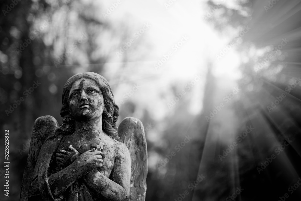 Black and white dramatic image of ancient statue of angel of death as ...