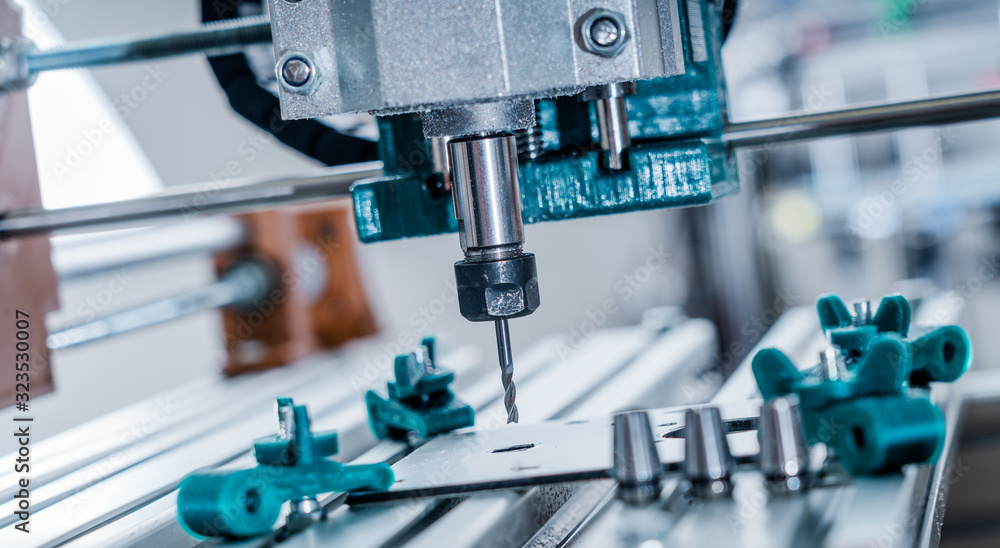 CNC milling machine cutting aluminium part. Stock Photo | Adobe Stock