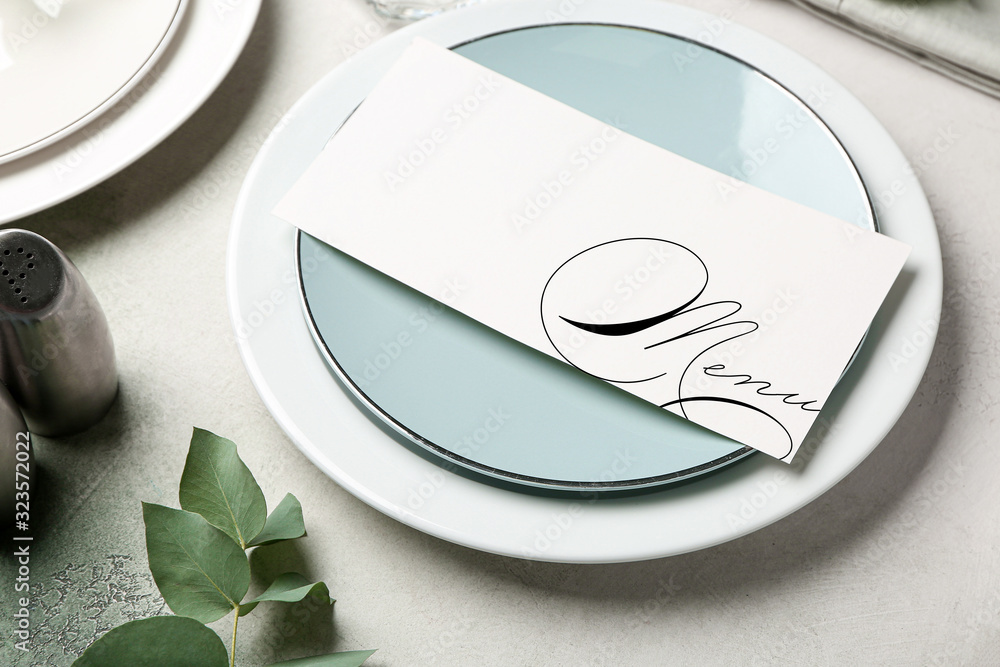 Beautiful table setting with menu on light background Stock Photo ...