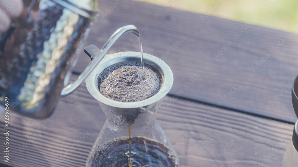 Hand drip coffee making pour over coffee with hot water being poured ...