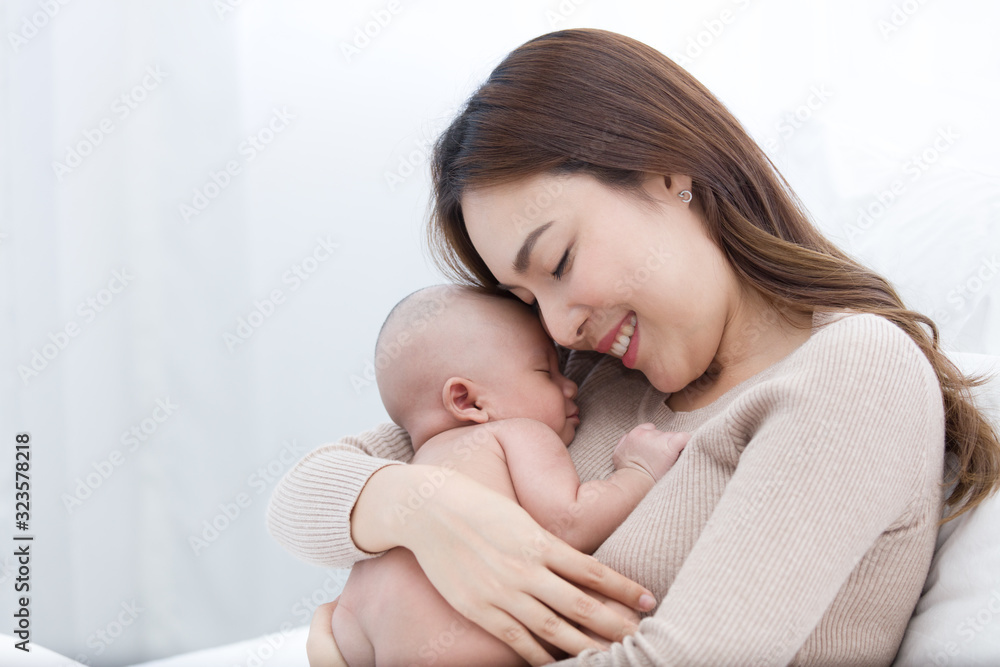 Mother hugging baby. Stock Photo | Adobe Stock