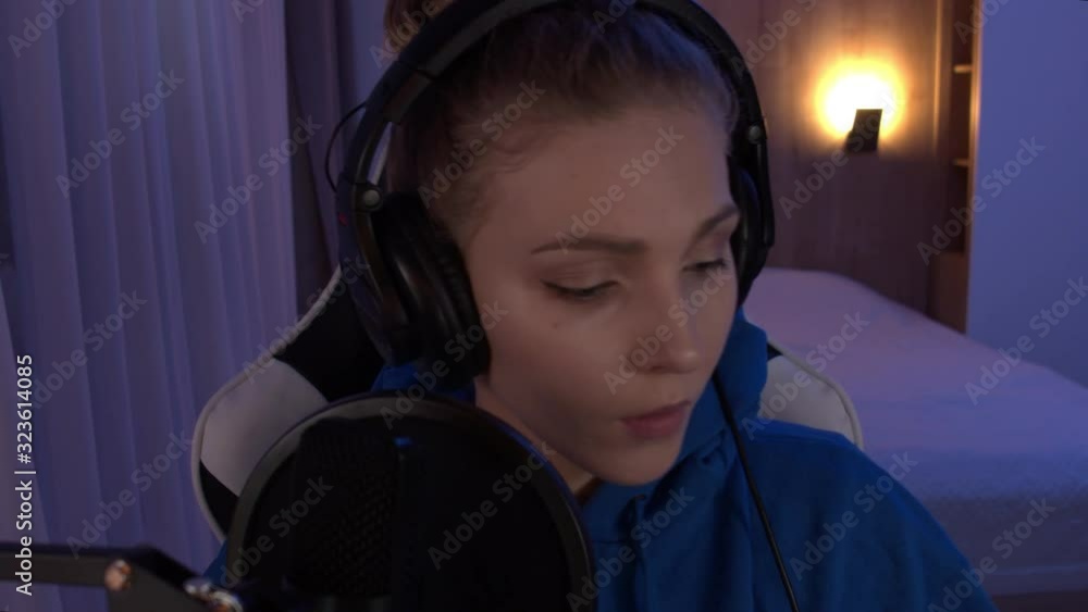POV webcam view, Caucasian teen girl gamer streamer putting on ...