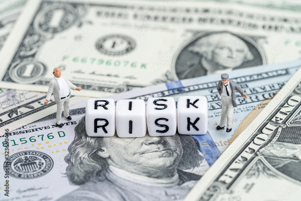 Risk management in investment or danger in money game, miniature people ...