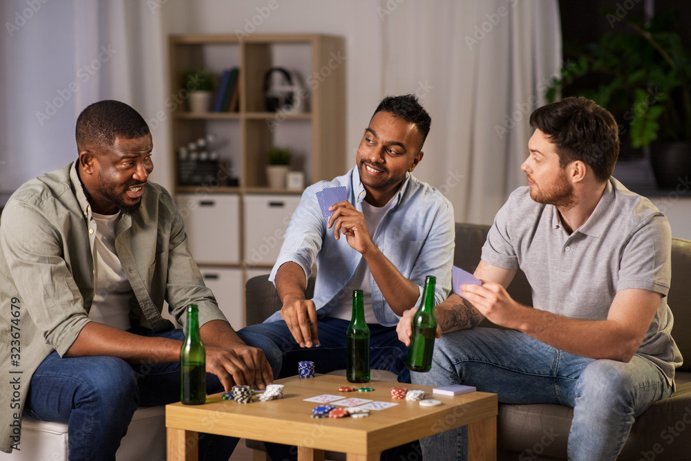 leisure games, friendship and gambling concept - happy male friends ...
