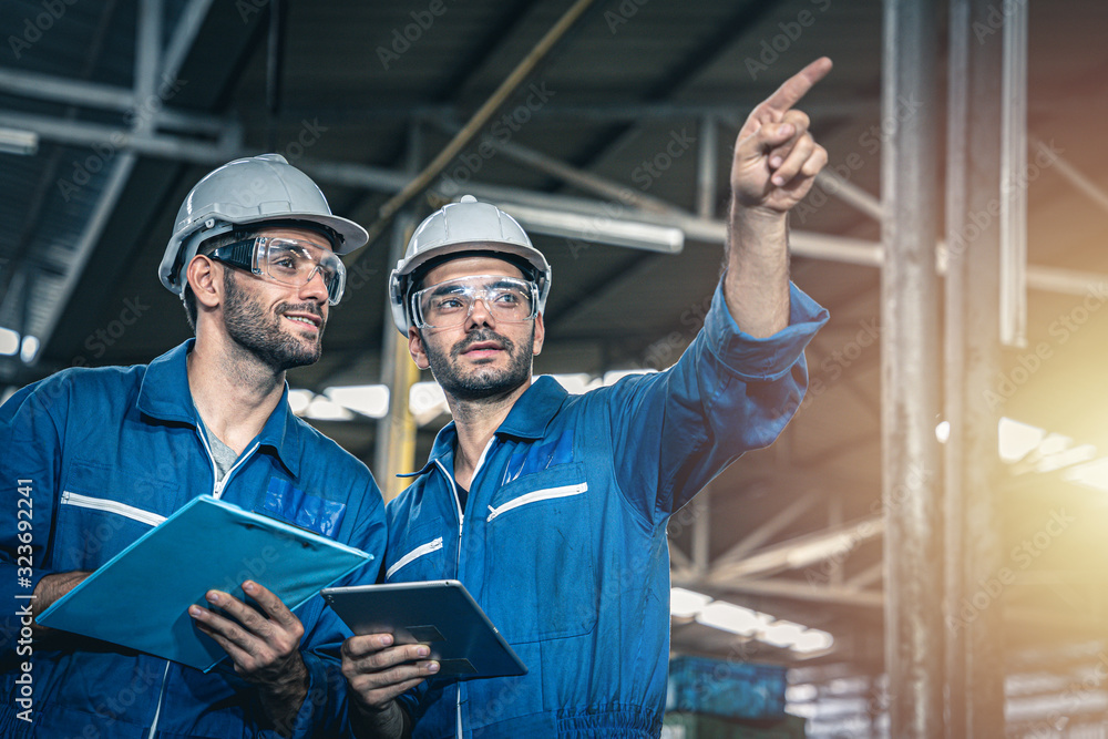 Inspector engineer pointing out the area for his colleague. Routine ...