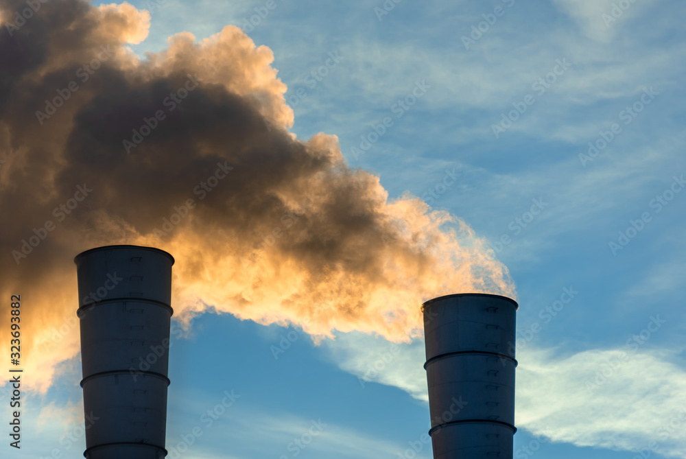 Industrial chimneys spewing smoke and soot in the blue sky polluting ...