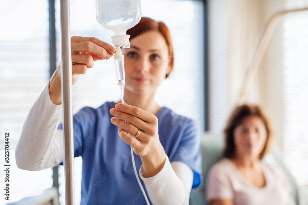 A nurse with IV drip and patient in bed in hospital room. Stock Photo ... A nurse with IV drip and patient in bed in hospital room. Stock Photo ...