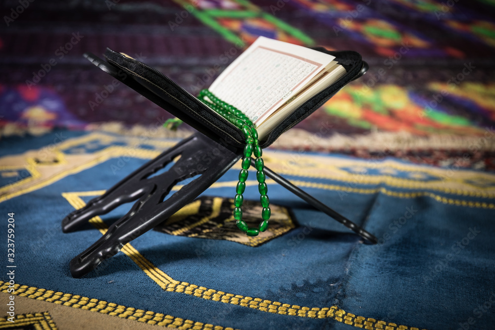 Koran book of muslim people. Holy muslim koran on eastern carpet in ...