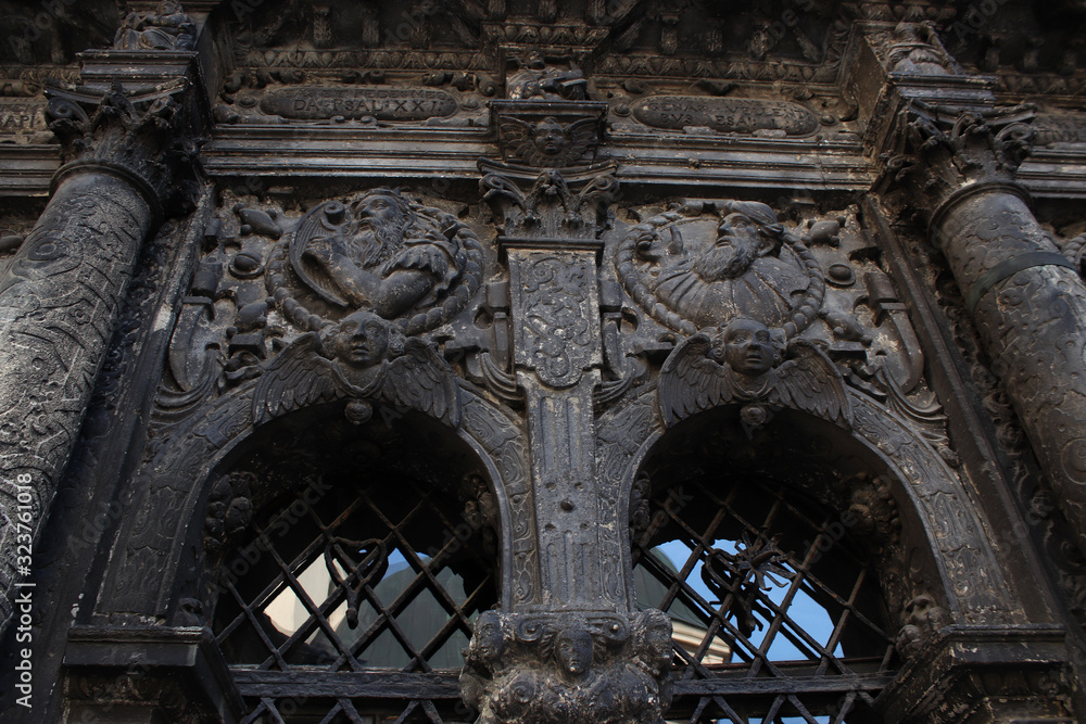 Columns and window with forged bars. Sooty from old age. Architectural ...