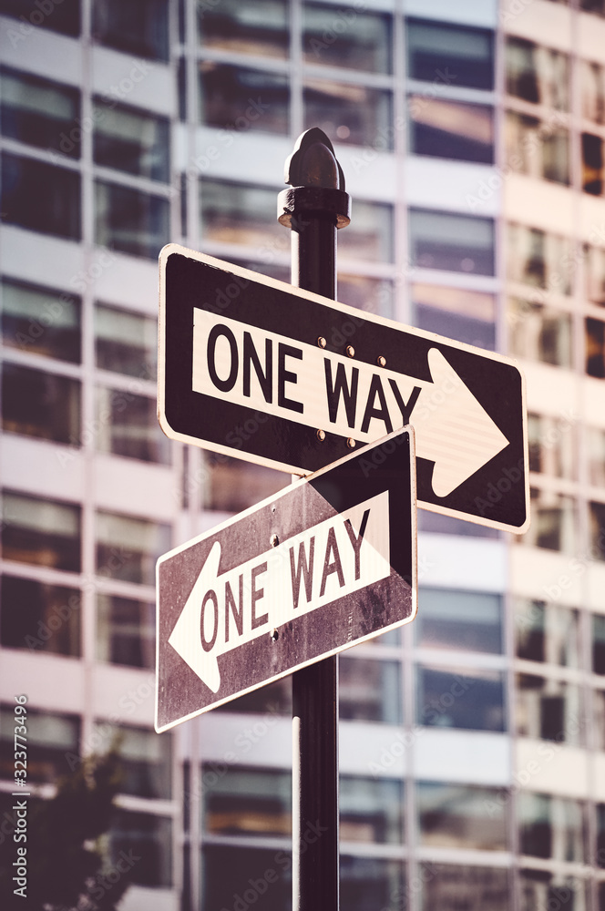 Retro toned picture of one way street signs in New York City, selective ...