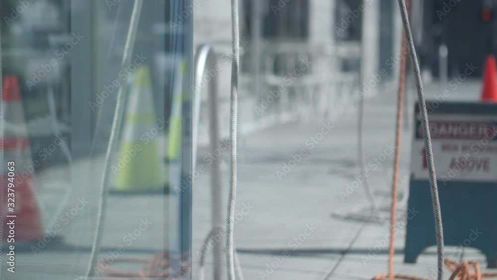 Pan of safety ropes and warning sign for high rise window washers Stock ...