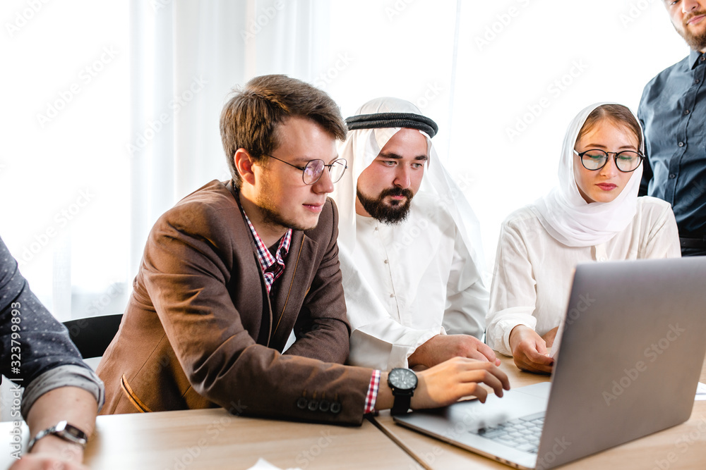 Presentation on a laptop with foreign representatives. A young guy ...