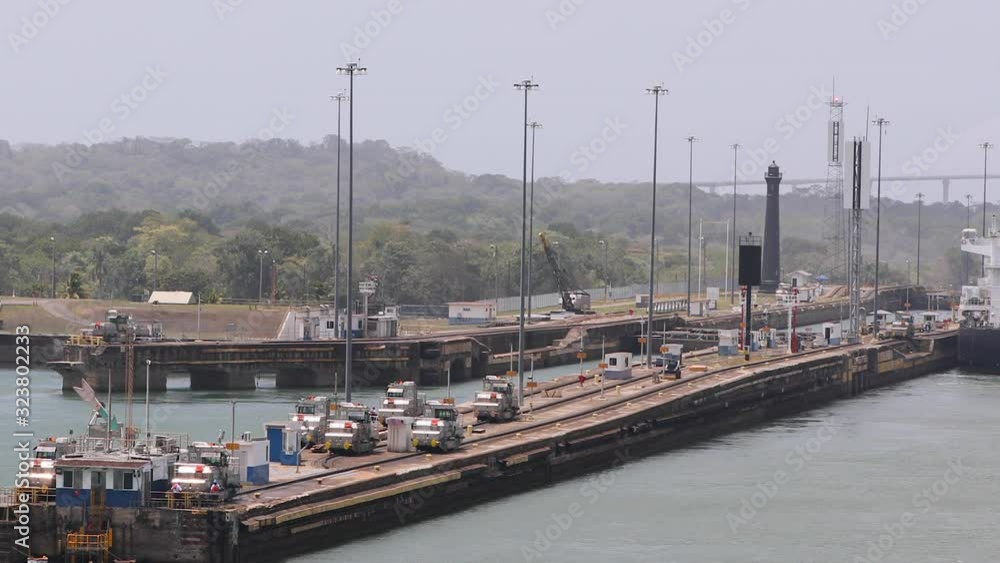 Panama Canal approaching locks and pier. The Panama Canal locks lifts a ...