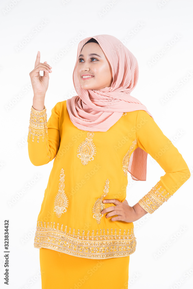 Beautiful female Muslim model in modern kurung and hijab, a modern ...