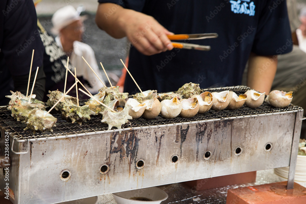 Photograph of an iron where large sea snails are cooked Stock Photo ...