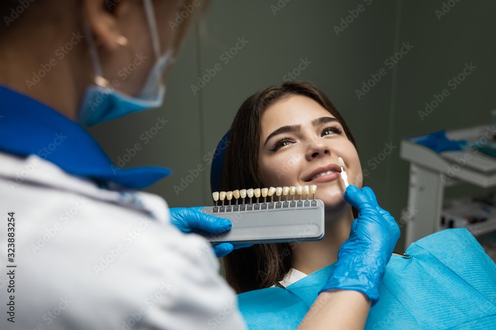 dentist in blue medical gloves and mask applying sample from tooth ...