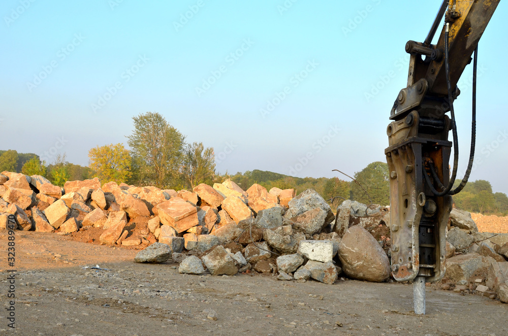 Excavator with hydraulic breaker hammer for the destruction of concrete ...