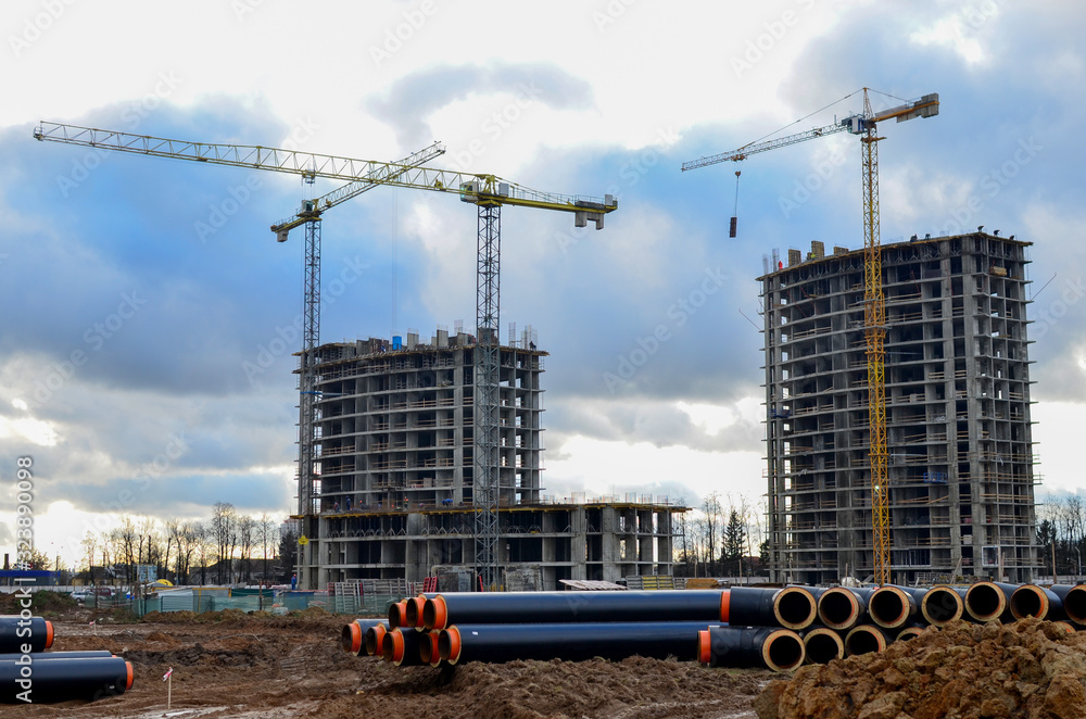 The drainage pipes at the large scale construction site against tower ...