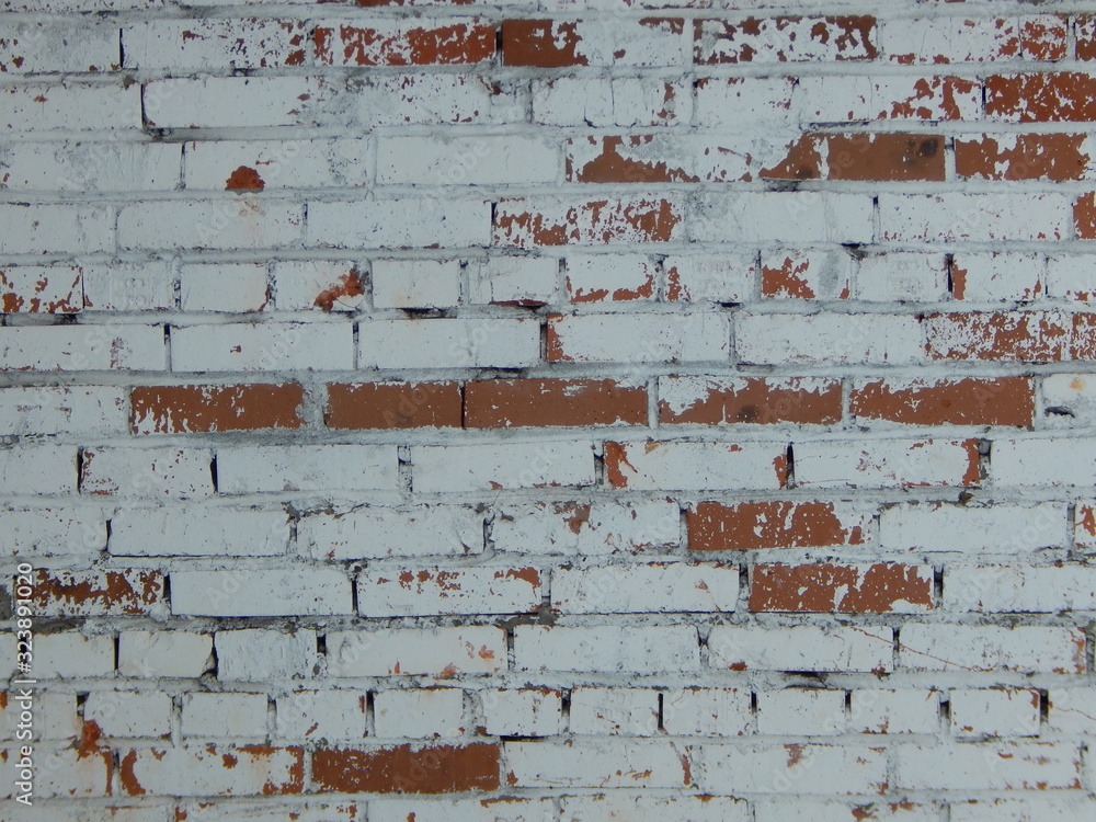 uneven brick wall painted white with several red spots and scuffs Stock ...