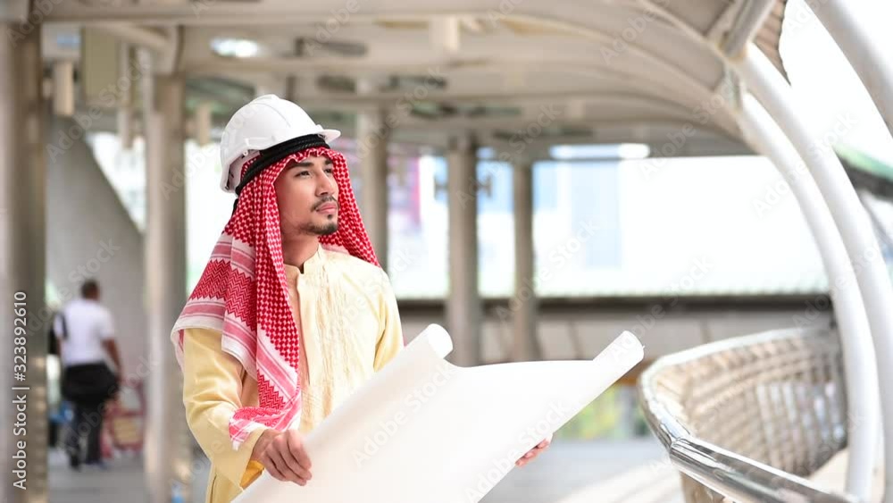 Arab civil engineer construction project hold blueprint, pointing at ...