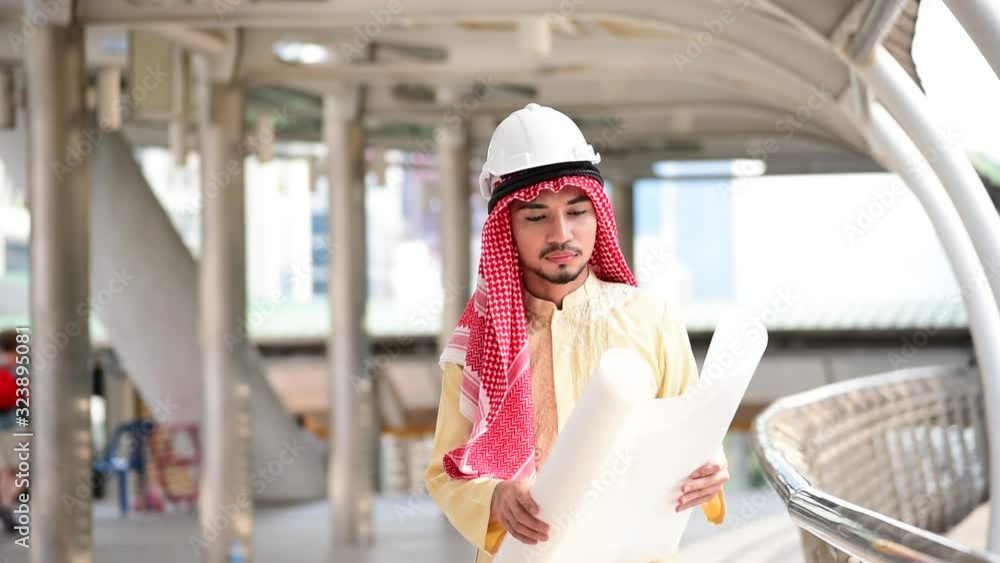 Arab engineer consult construction project together hold blueprint ...