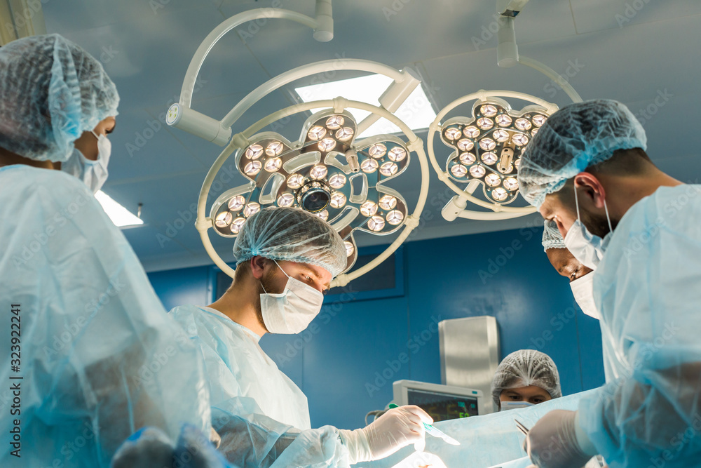 An international team of doctors performs a complex surgical operation ...