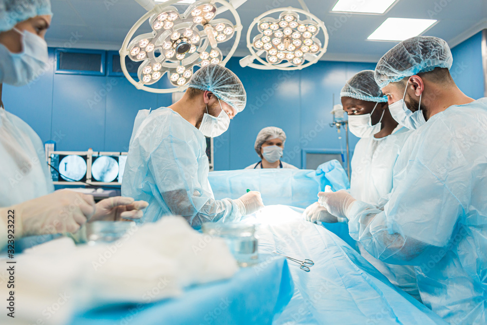 An international team of doctors performs a complex surgical operation ...