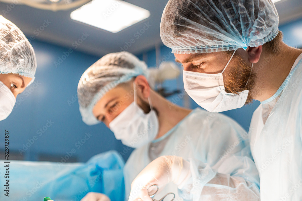 An international team of doctors performs a complex surgical operation ...