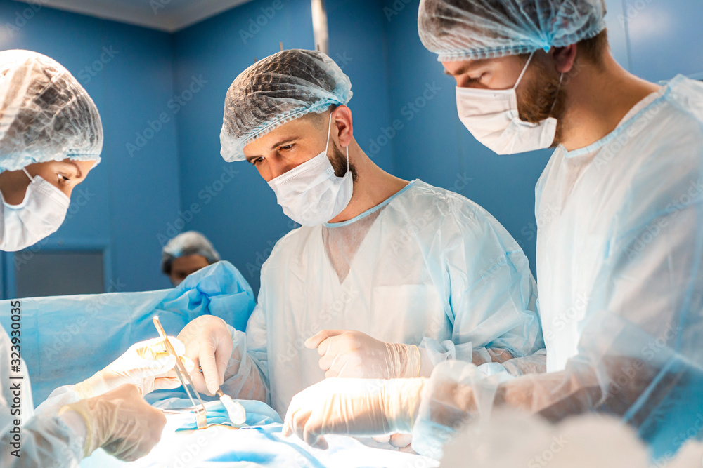 An international team of doctors performs a complex surgical operation ...