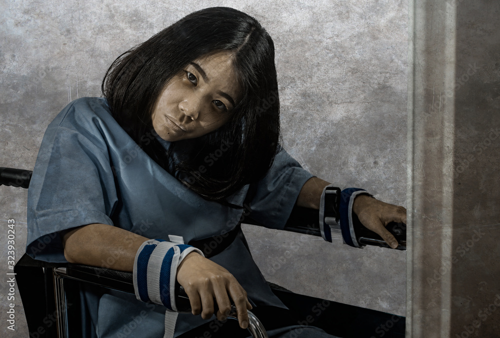 young crazy and mentally insane Asian woman restrained in wheelchair at ...
