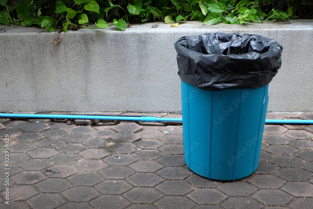 Plastic bins are placed in public places so people can throw away ...