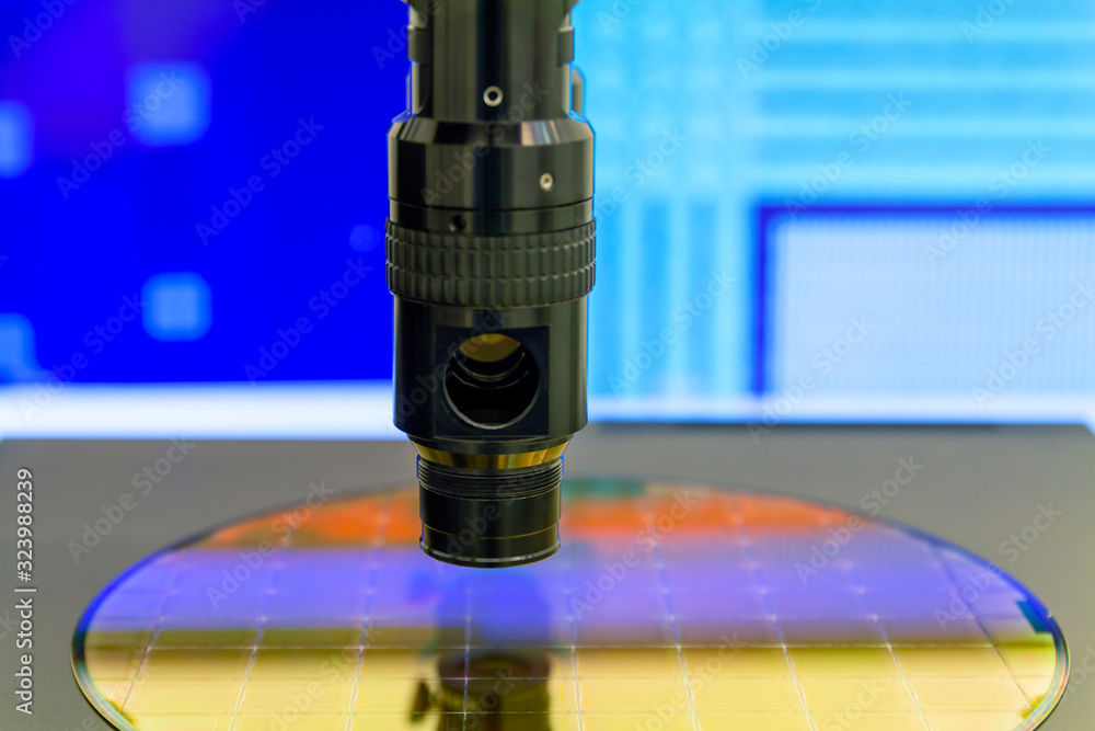 Silicon wafer with semiconductor microchip on machine process examining ...