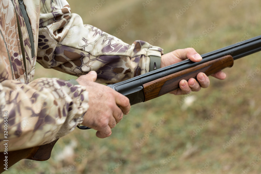 Charges a hunting smooth-bore rifle, hunting a pheasant with dogs. A ...