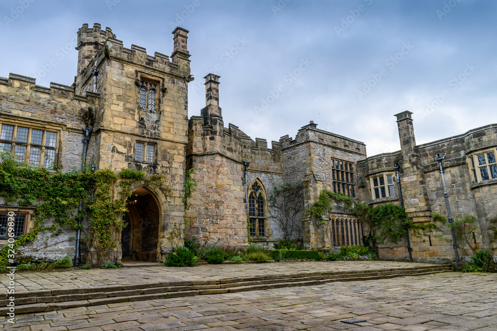 Exterior view of a Tudor fortified house, with a central entrance tower ...
