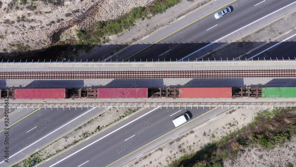 Freight Train hauling a long load of Shipping Containers crossing a ...