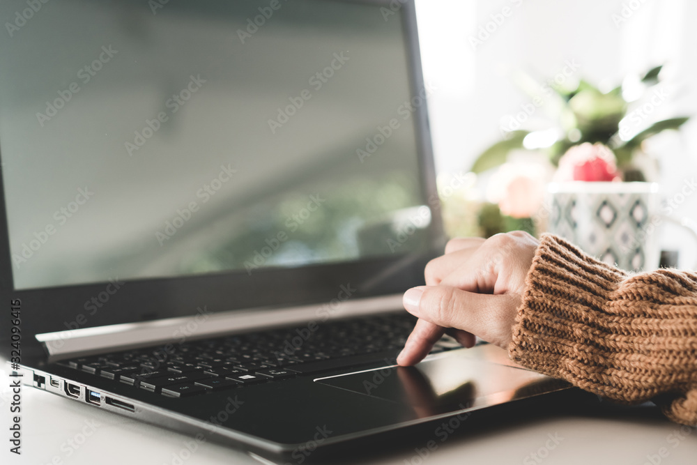 Woman hand using laptop or smartphone to work study on work desk with ...